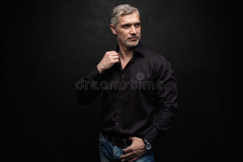 Middle-aged Good Looking Man Posing in Front of a Black Background with ...