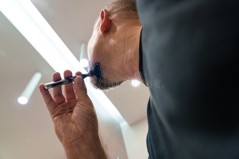 Middle-aged Handsome Man Using Razor in Bathroom Stock Photo - Image of ...