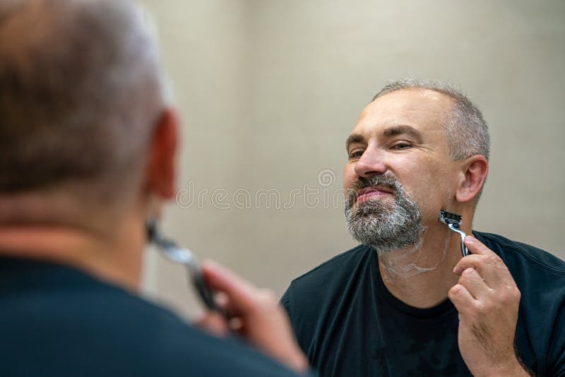 Middle-aged Handsome Man Using Razor in Bathroom Stock Photo - Image of ...