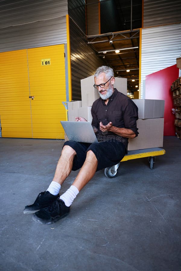 Middle-aged Male Sat Down on a Cart with Boxes Stock Image - Image of ...