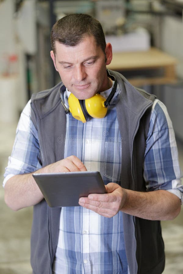 Middle Aged Male Worker Using Tablet in Factory Stock Photo - Image of ...