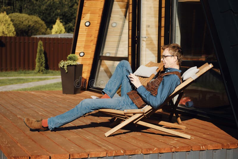 Middle Aged Man in Brown Vest Reading Message on Smartphone Sitting on ...