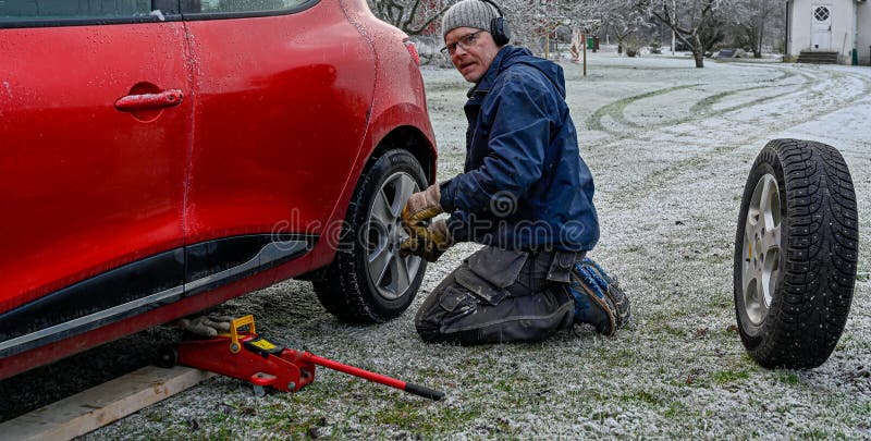 Middle Aged Man Changing Tires at Home Stock Image - Image of wheel ...