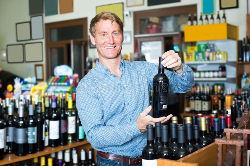 Middle-aged Man Customer Buying Bottle of Wine Stock Photo - Image of ...