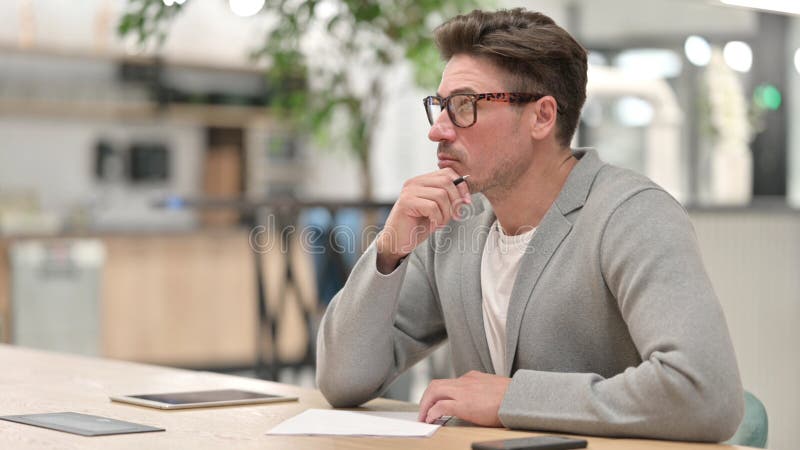 Middle Aged Man Doing Paperwork Stock Image - Image of contract ...