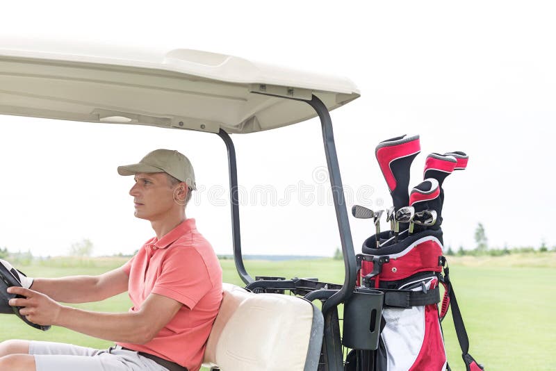 Middle-aged Man Driving Golf Cart at Course Stock Photo - Image of ...