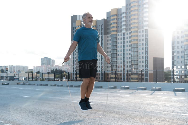 Middle-aged Man Exercising with Jump-rope Outdoors. Stock Photo - Image ...