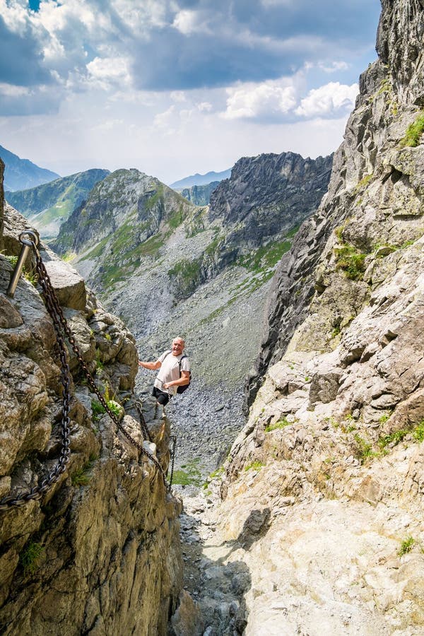 Middle Aged Man Hiking and Climbing Mountains. Stock Image - Image of ...