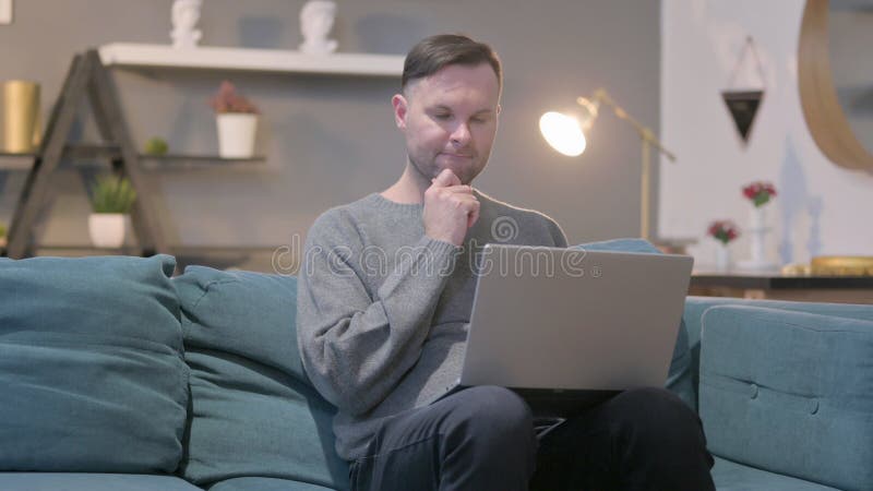 Casual Man with Laptop Thinking on Sofa Stock Photo - Image of sofa ...