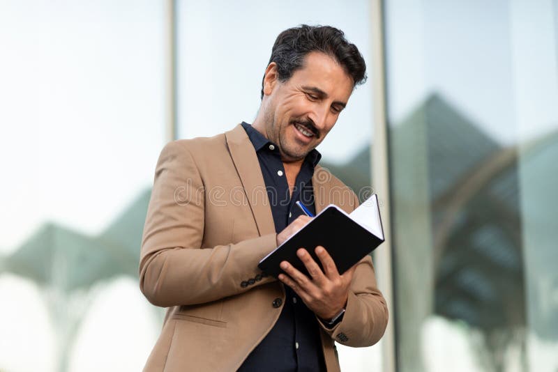 Middle Aged Man Manager Taking Notes in Notepad Outdoors Stock Image ...