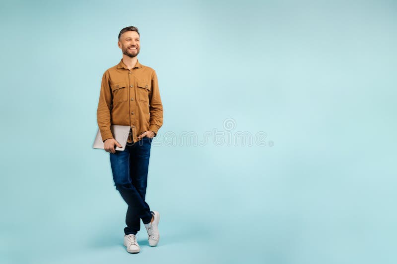 Middle-aged Man Posing Holding PC Laptop Standing at Blue Studio, Full ...