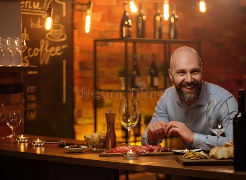 Middle-aged Man Sitting Behind Bar Counter Stock Photo - Image of glass ...