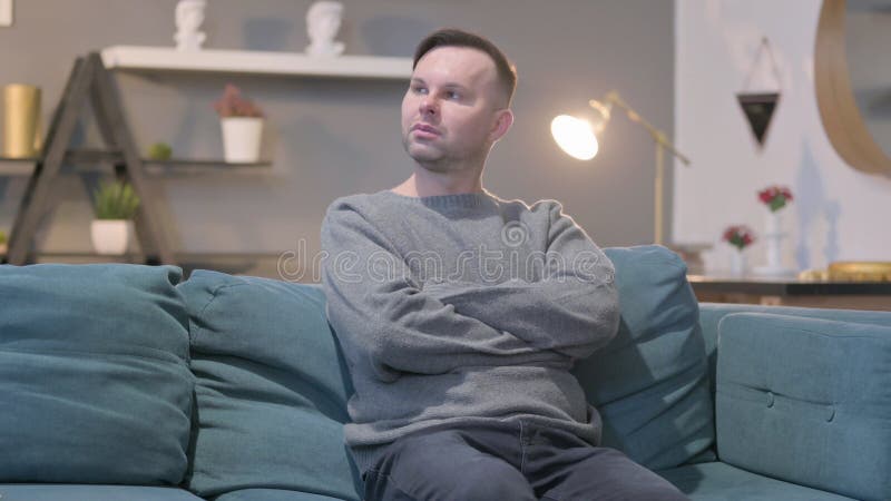 Casual Man Sitting on Sofa Thinking Stock Photo - Image of busy ...