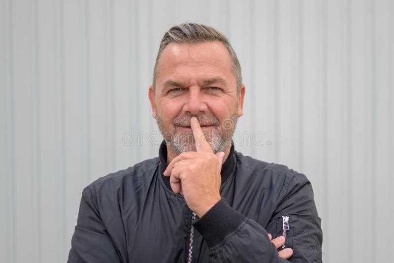 Middle-aged Man Standing Deep in Thought with Finger on the Lips Stock ...