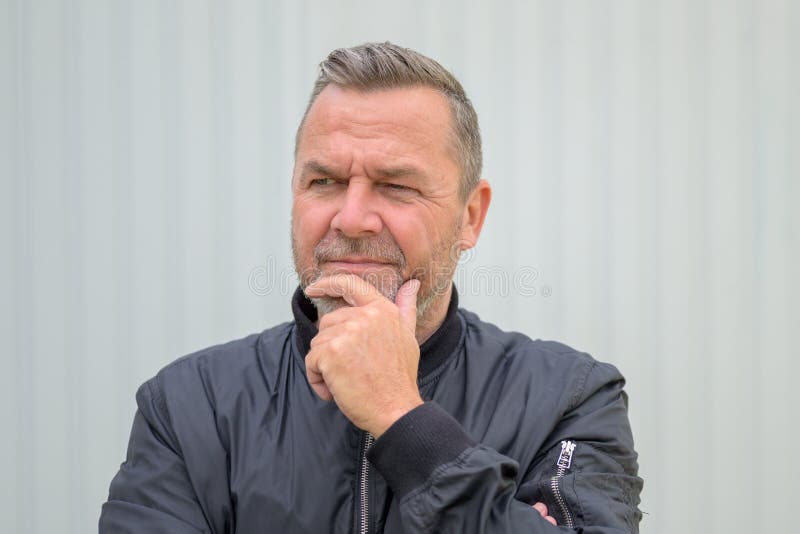 Middle-aged Man Standing Deep in Thought with Hand on Chin Stock Image ...