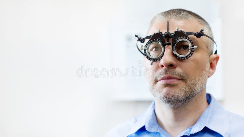 Middle Aged Man Undergoing Detailed Vision Test while Using Phoropter ...