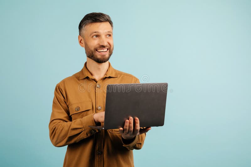 Middle Aged Man Using Laptop Computer Browsing Internet and Working ...