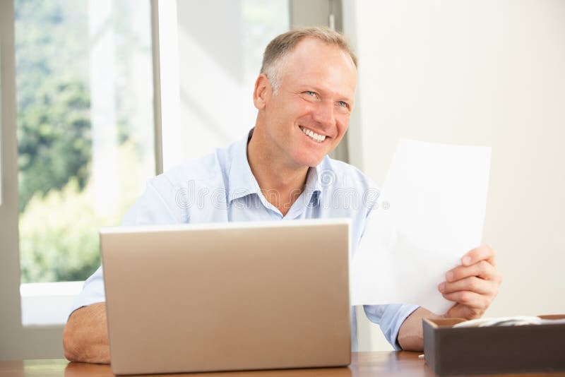 Middle Aged Man Using Laptop at Home Stock Photo - Image of computer ...