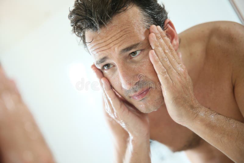 Middle-aged Man Using a Lotion on His Face Stock Image - Image of foam ...
