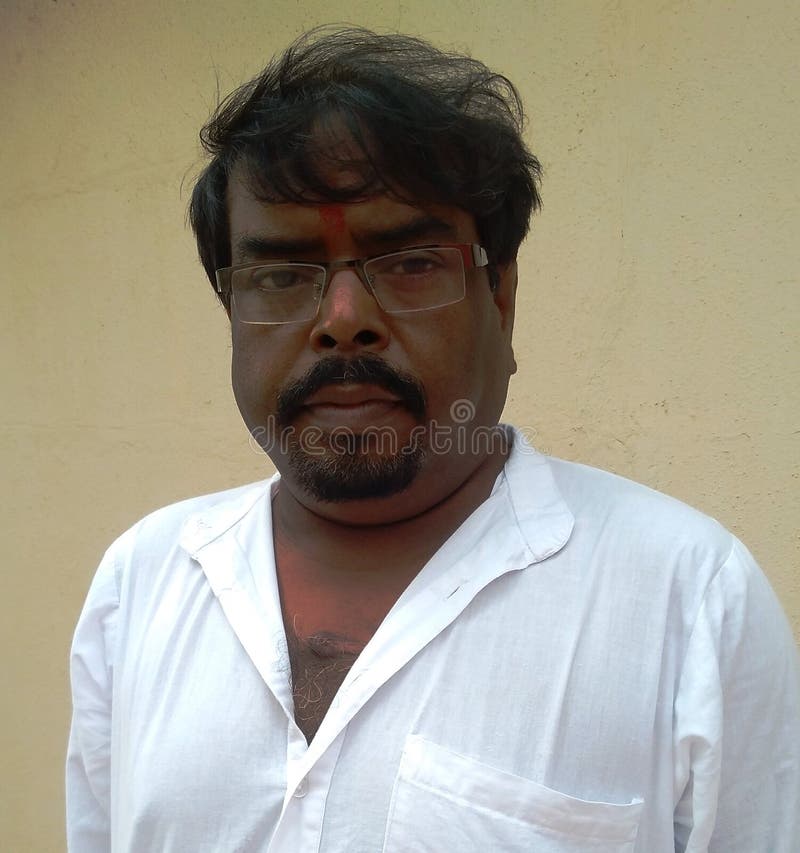 A Middle-aged Man Wearing a Kurta with Tilak and Glasses Editorial ...
