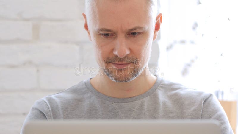 Middle Aged Man Working on Laptop, Front View Stock Photo - Image of ...