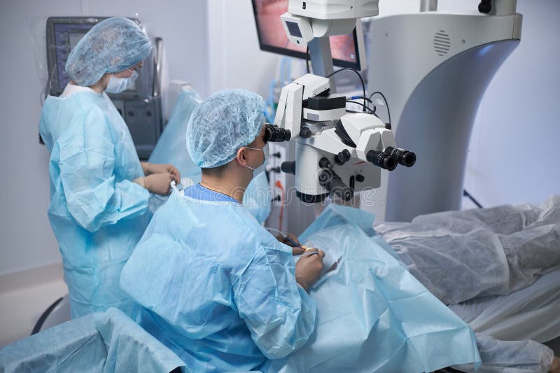 Middle Aged Male Surgeon Performing Operation Stock Photos - Free ...