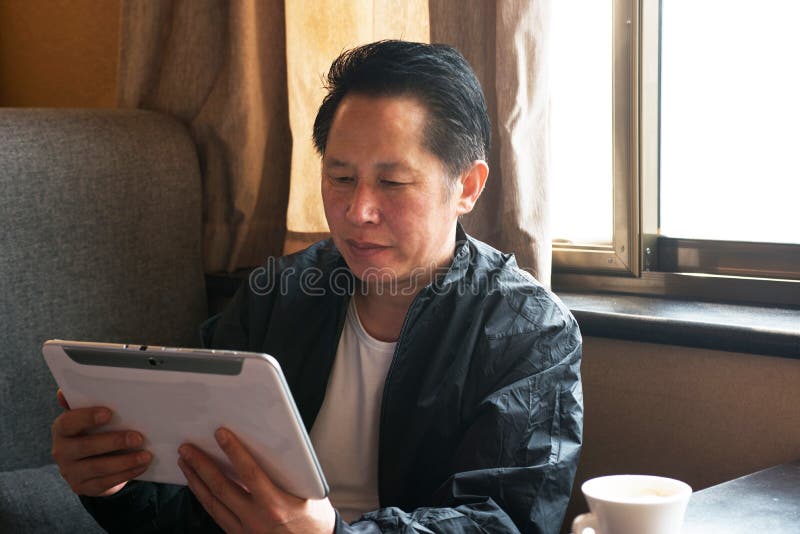 Middle-aged men Tablet PC stock image. Image of sitting - 39325587