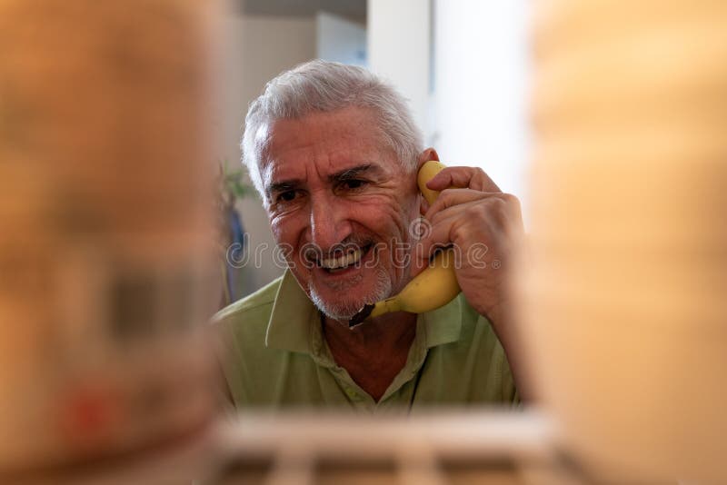 Middle Aged Single Man Having Fun Using a Banana As a Phone in Front of ...