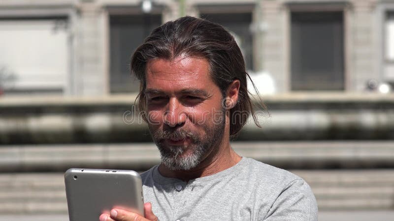 Handsome Spanish Male Using Tablet Stock Image - Image of gadget, looks ...