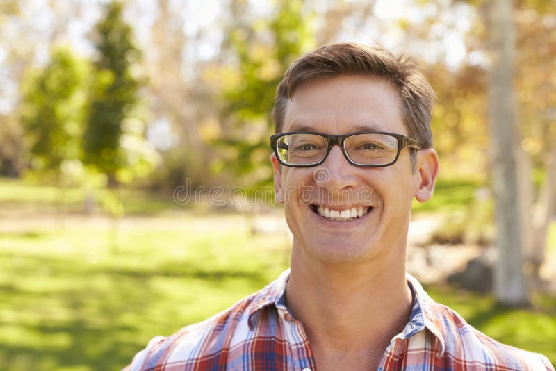 Middle Aged White Man in Glasses Smiling To Camera in a Park Stock ...