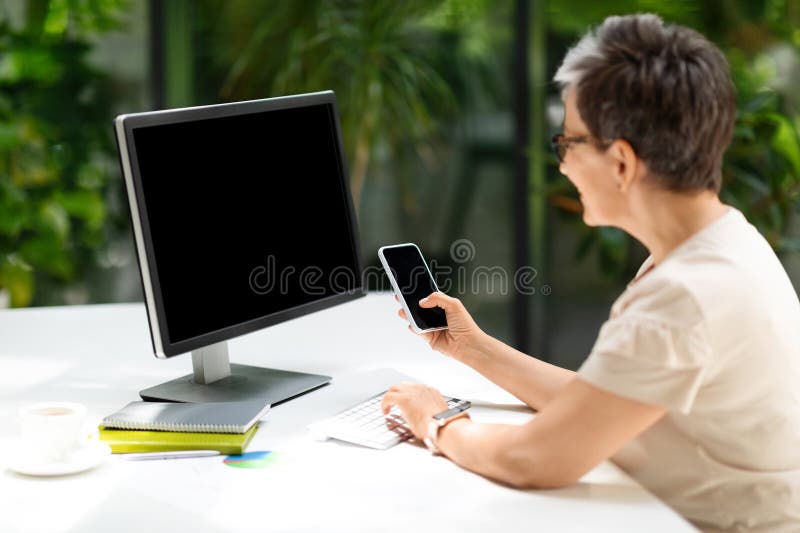 Middle Aged Woman Project Manager Using Computer, Smartphone at Office ...