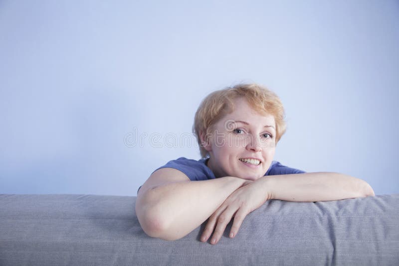Middle Aged Woman Put Her Hands on the Back of the Couch Stock Photo ...