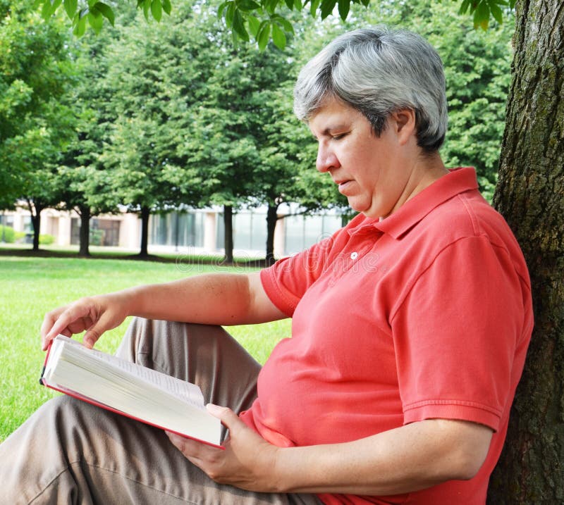 Middle-aged Woman Reading Book By Tree Stock Image - Image of people ...