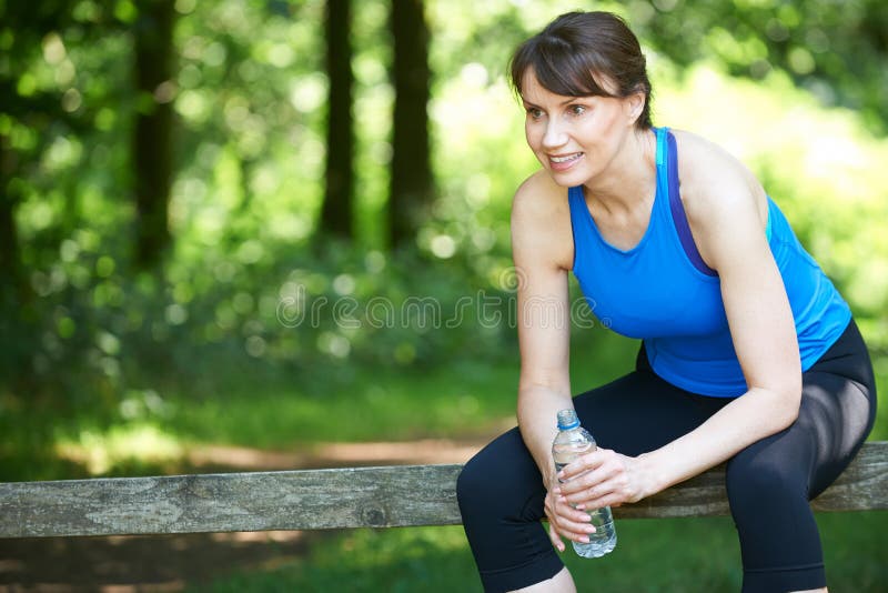 Middle Aged Woman Resting after Exercise Stock Image - Image of space ...