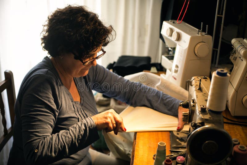 Middle aged woman sewing stock image. Image of cloth - 51172005