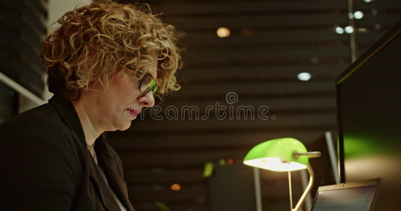 A Middle-aged Woman, Working at Midnight, Engages in Calculating and ...