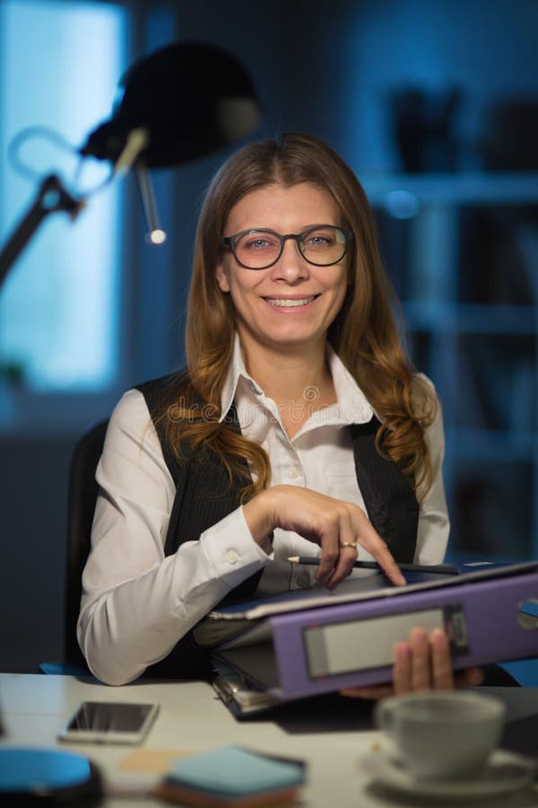 Middle-aged Woman Working in the Office until the Night on Overt Stock ...