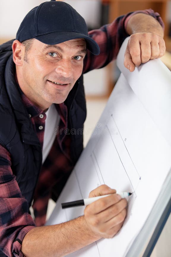 Middle-aged Workman Drawing Design on Flip Chart Stock Image - Image of ...