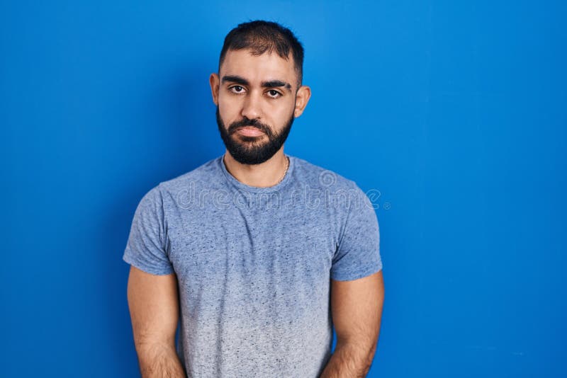 Middle East Man with Beard Standing Over Blue Background Depressed and ...