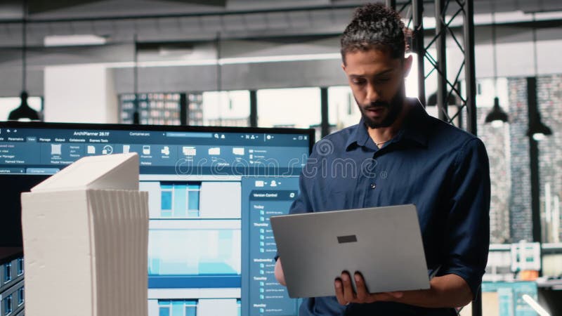 Middle Eastern Architect Reviews Blueprints for Construction Master ...