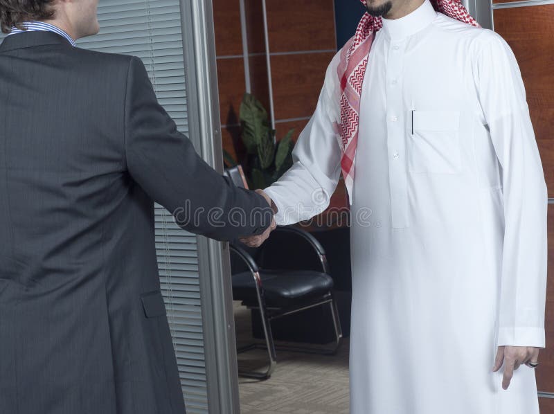Middle Eastern and Caucasian Businessmen Shaking Hands, in an of Stock ...