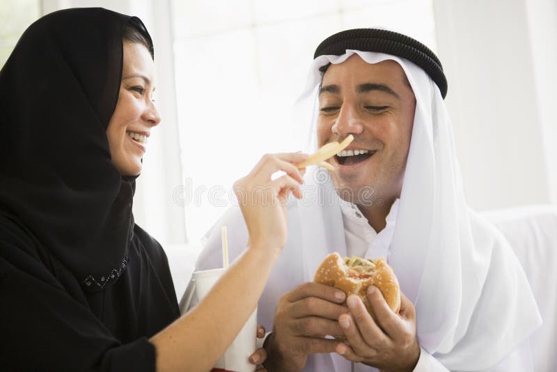 A Middle Eastern Couple Sharing a Fast Food Meal Stock Photo - Image of ...