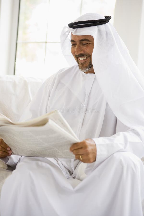 A Middle Eastern Man Reading a Newspaper Stock Photo - Image of sitting ...