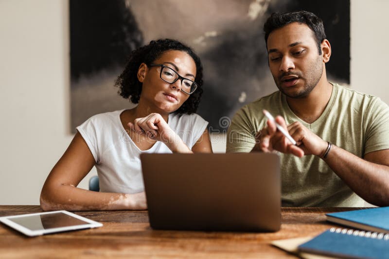 Middle Eastern Man and Woman Working with Laptop Together Stock Photo ...