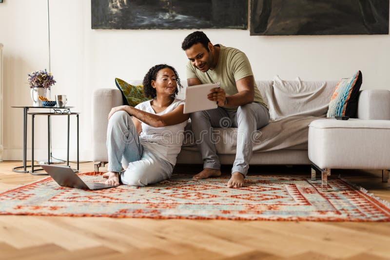 Middle Eastern Man and Woman Talking while Using Tablet Computer and ...