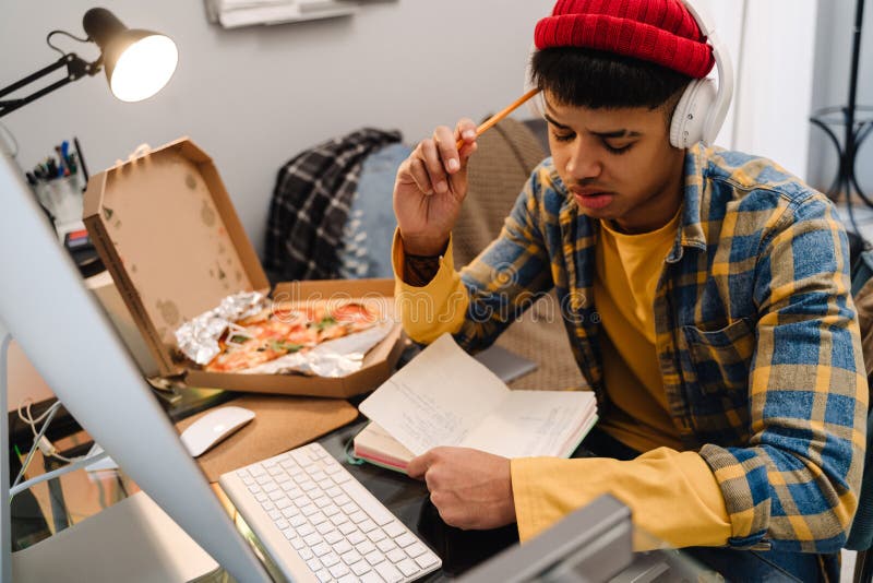 Middle-eastern Teenage Boy Using Computer while Studying at Home Stock ...