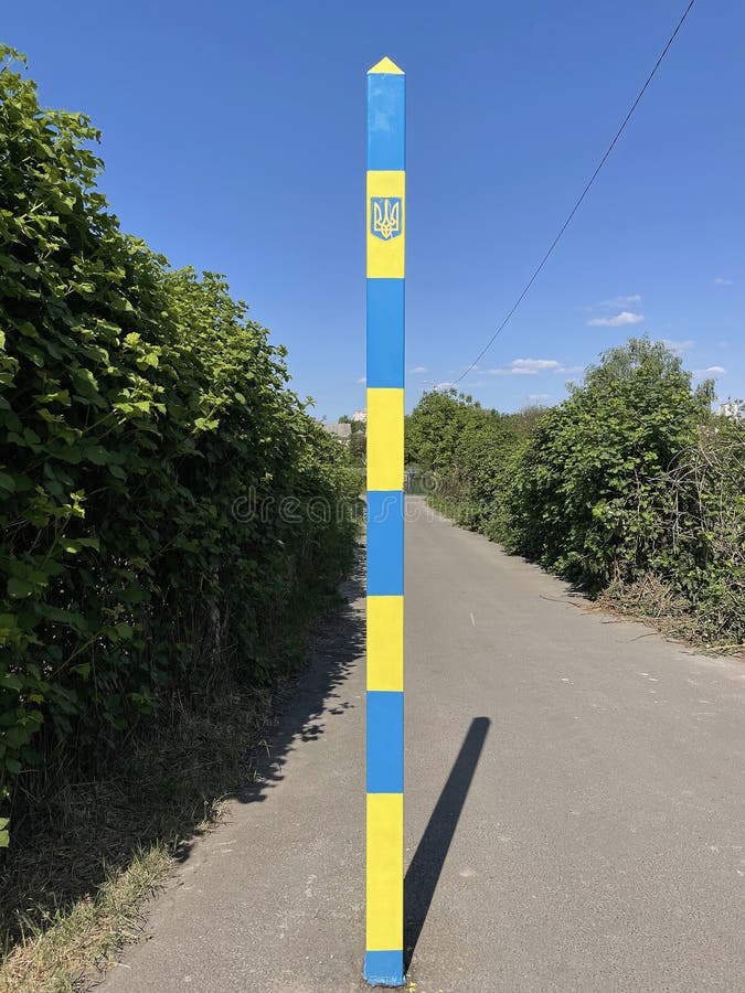 In the Middle of the Footpath There is a Pillar Painted Blue and Yellow ...