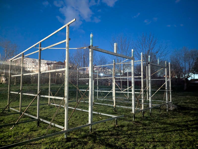 A Metal Structure Sits in a Grassy Field at Night Stock Photo - Image ...