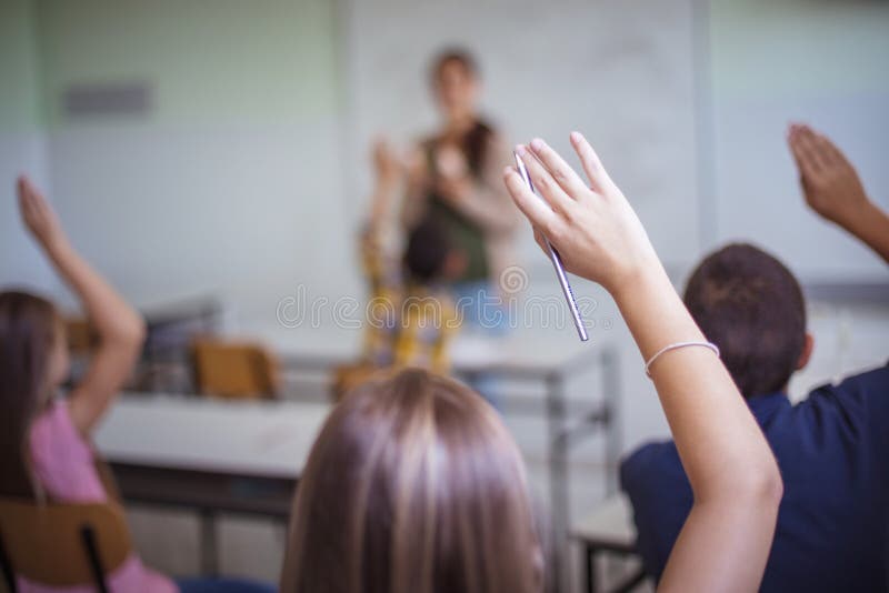 Students Raising Their Arms on a Class Stock Image - Image of girls ...