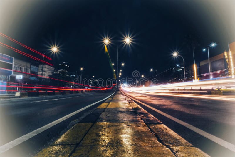 In the Middle of a Highway Divider with Light Trails of Vehicles at ...